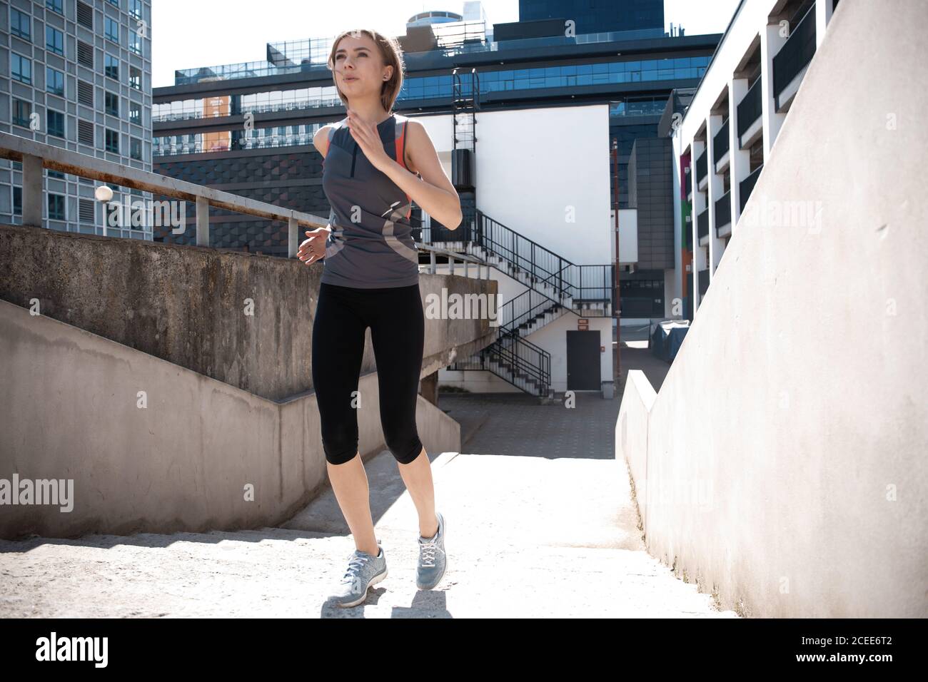 Portrait of a healthy young woman running outdoors Stock Photo - Alamy