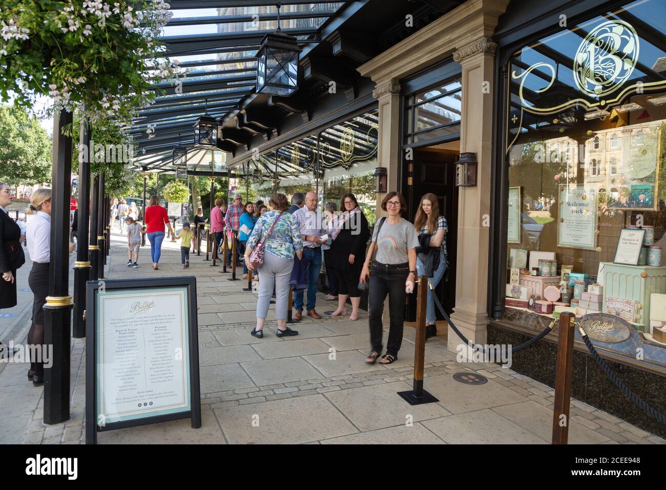 Bettys Harrogate ; a crowd of people in a queue waiting to get in to ...