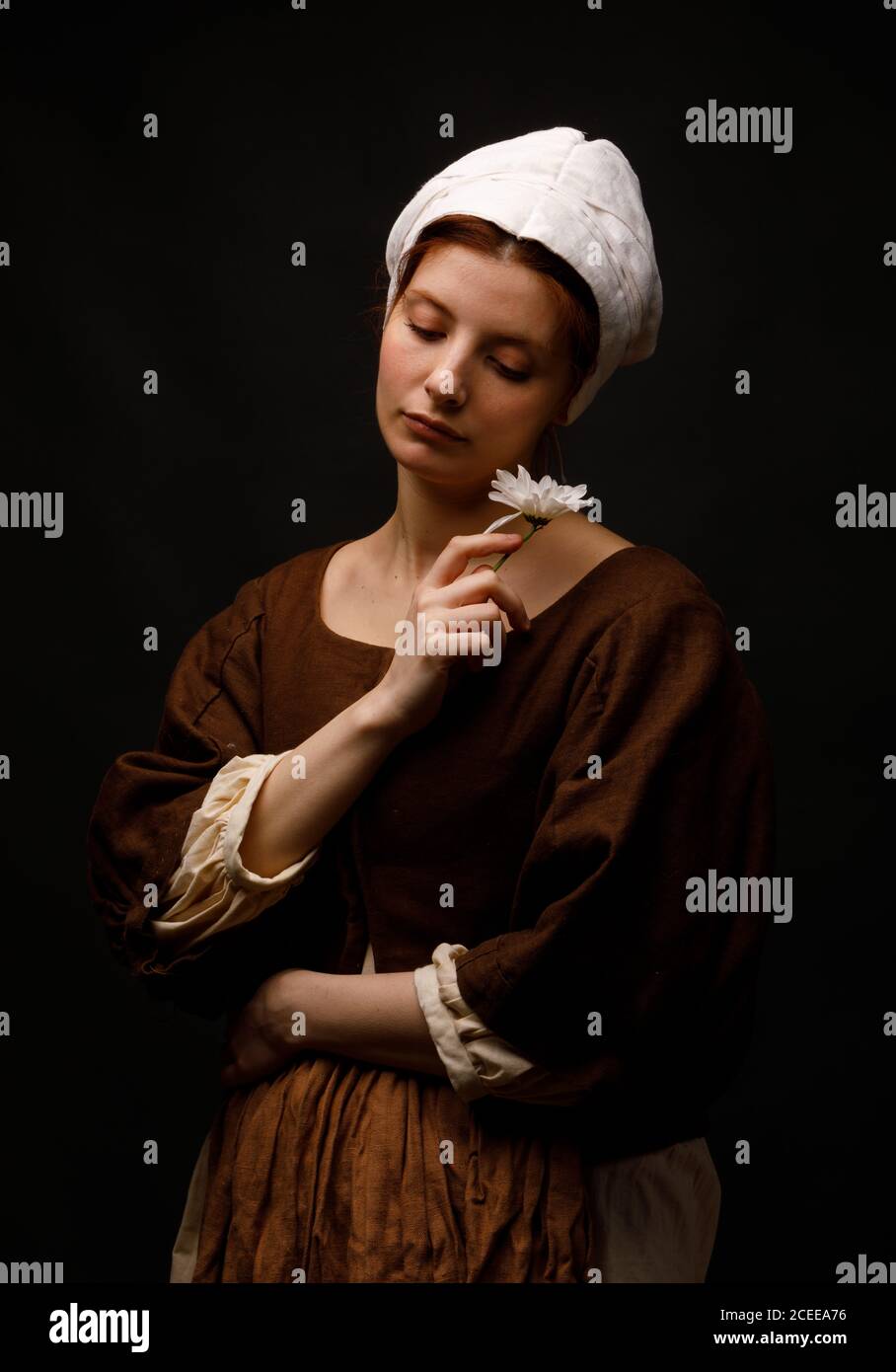 Medieval maid holding flower Stock Photo - Alamy