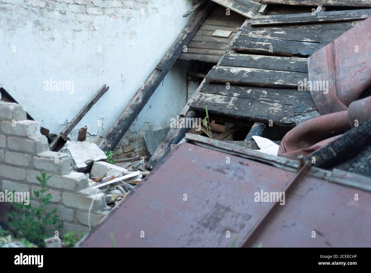 collapsed roof of a building house, collapse after a fire, ruins of ...
