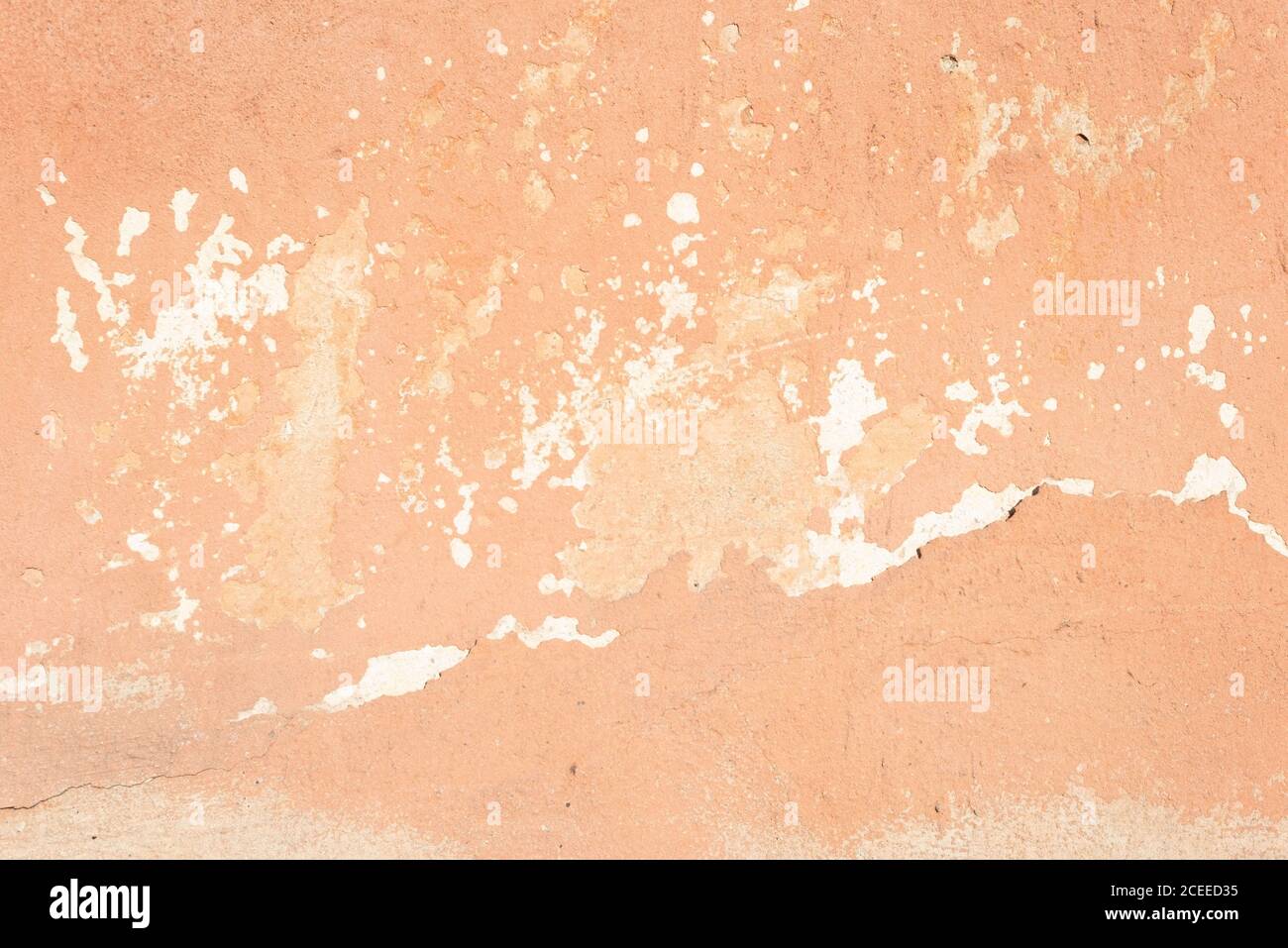 beige cracked plaster texture, with elements of rubbed white paint ...