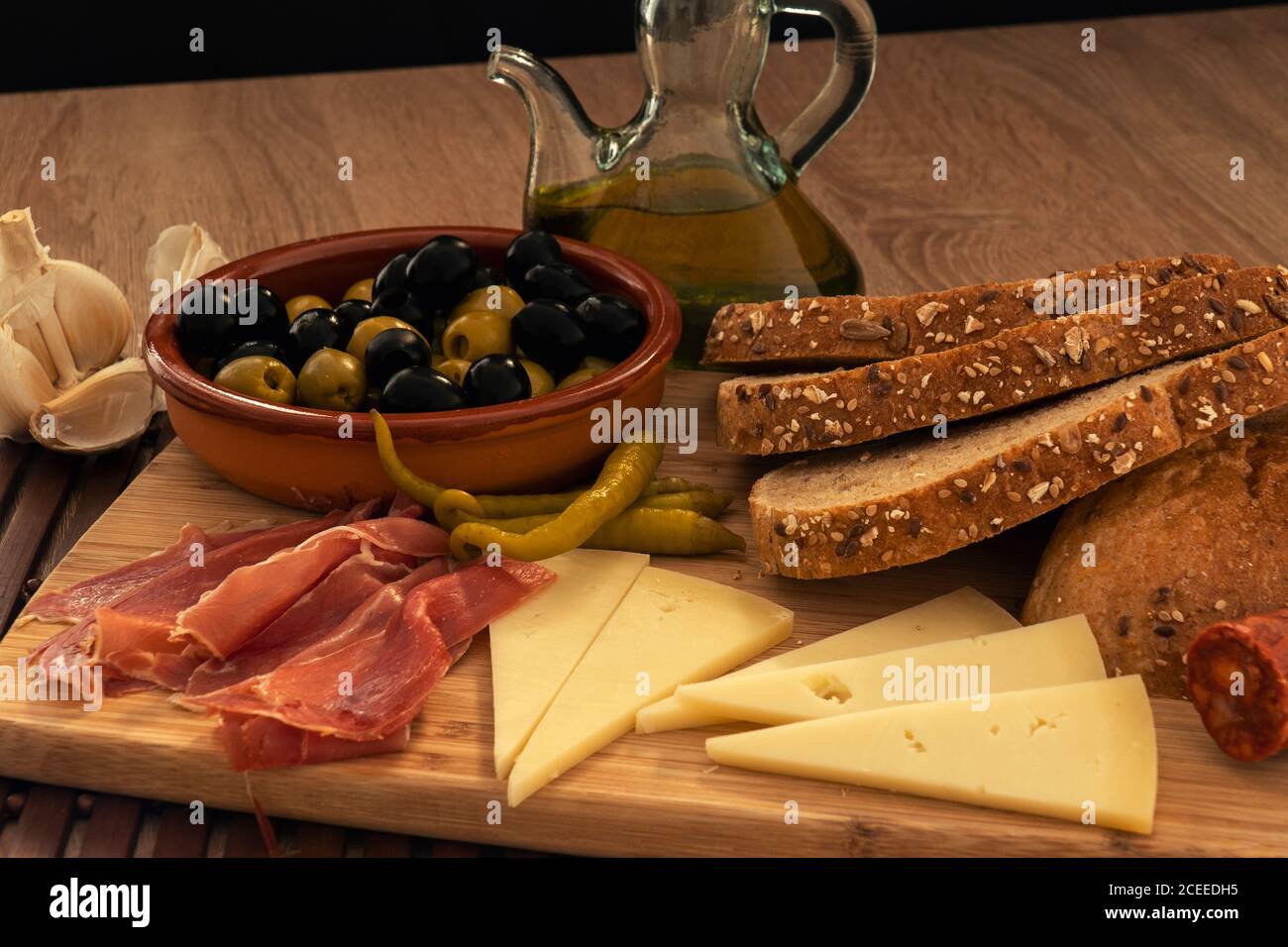 Wooden table with some spanish typical food in a dark scene Stock Photo ...