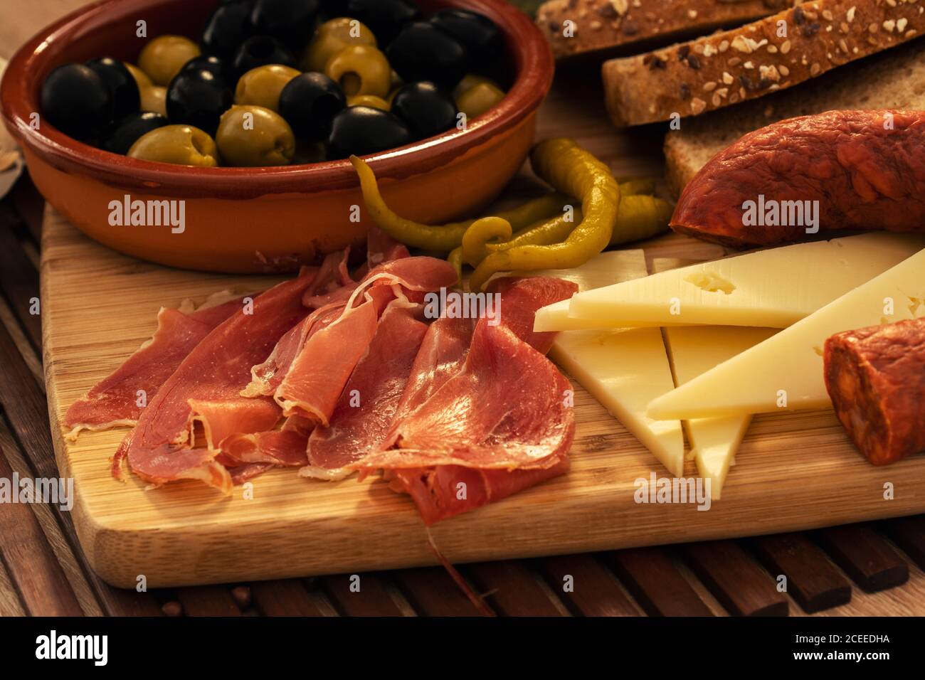 Wooden table with some spanish typical food in a dark scene Stock Photo ...