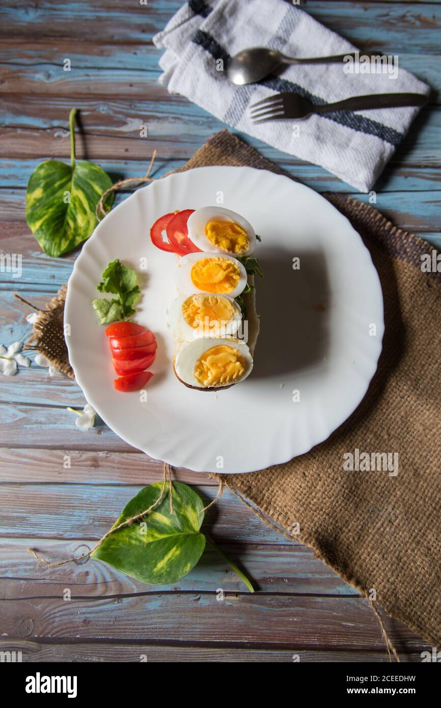 Eggs and bread with condiments. Poached egg and bacon. Boiled eggs and ...