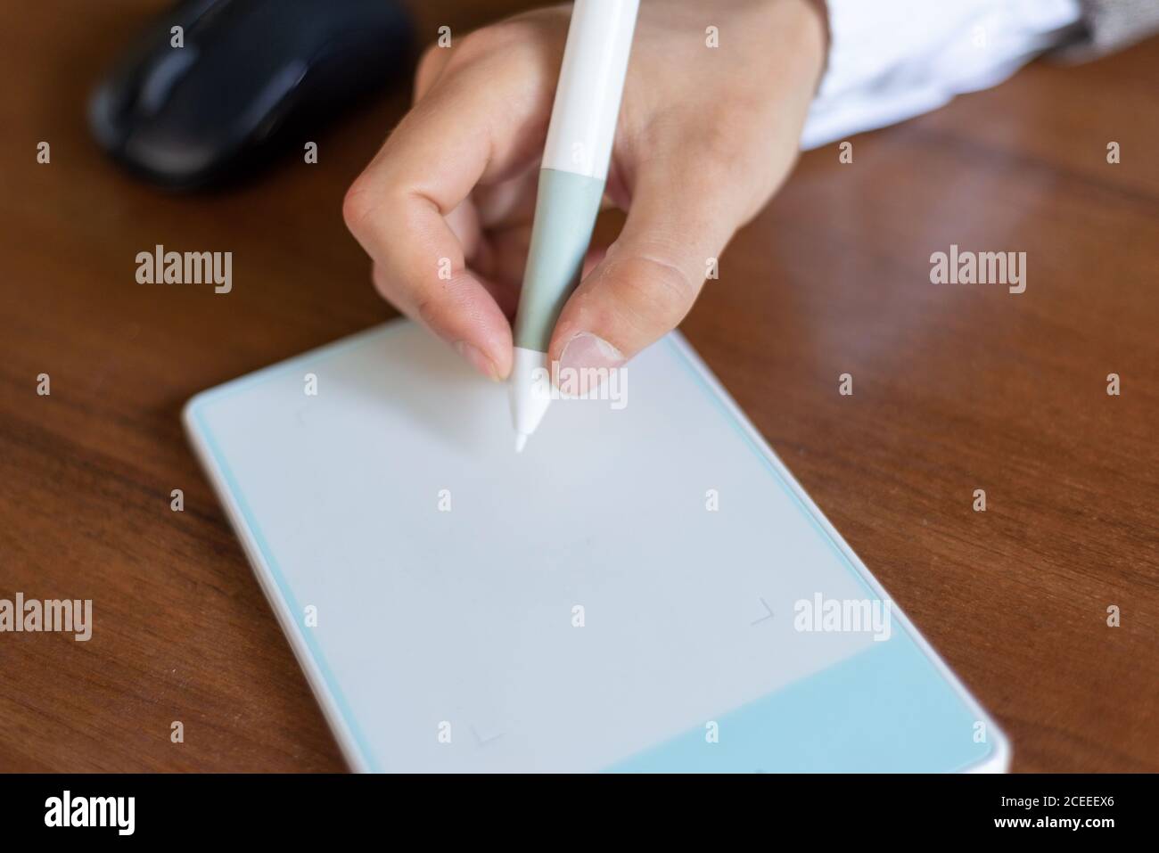 businessman sitting at the table, signs in a graphics tablet with a ...