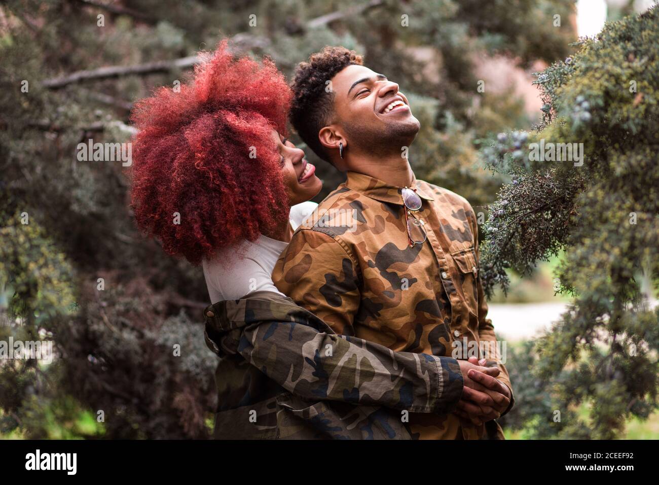 Beautiful couple kissing among trees Stock Photo - Alamy