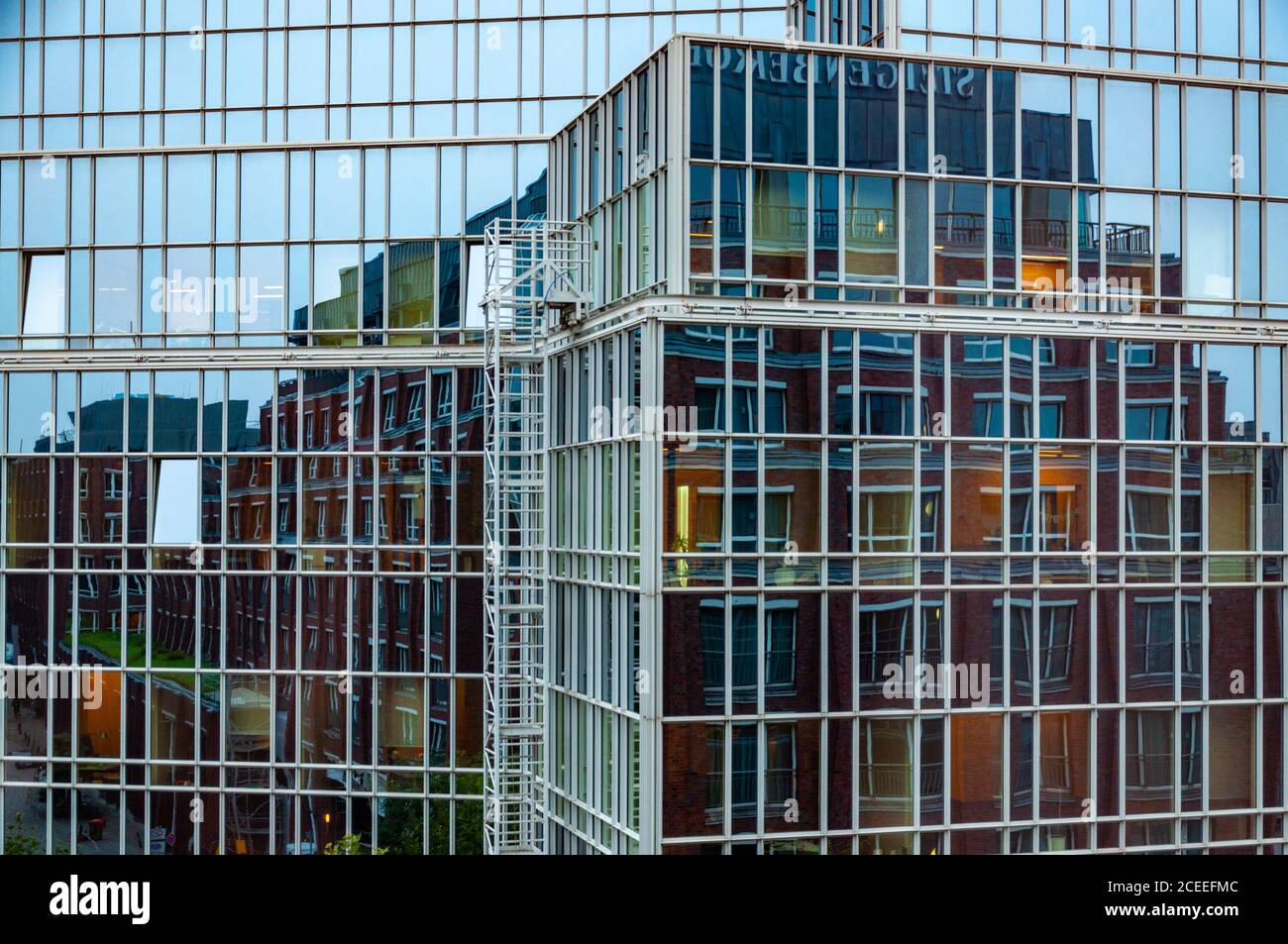 Corner of corporate building skyscraper with opened windows on mirrored ...