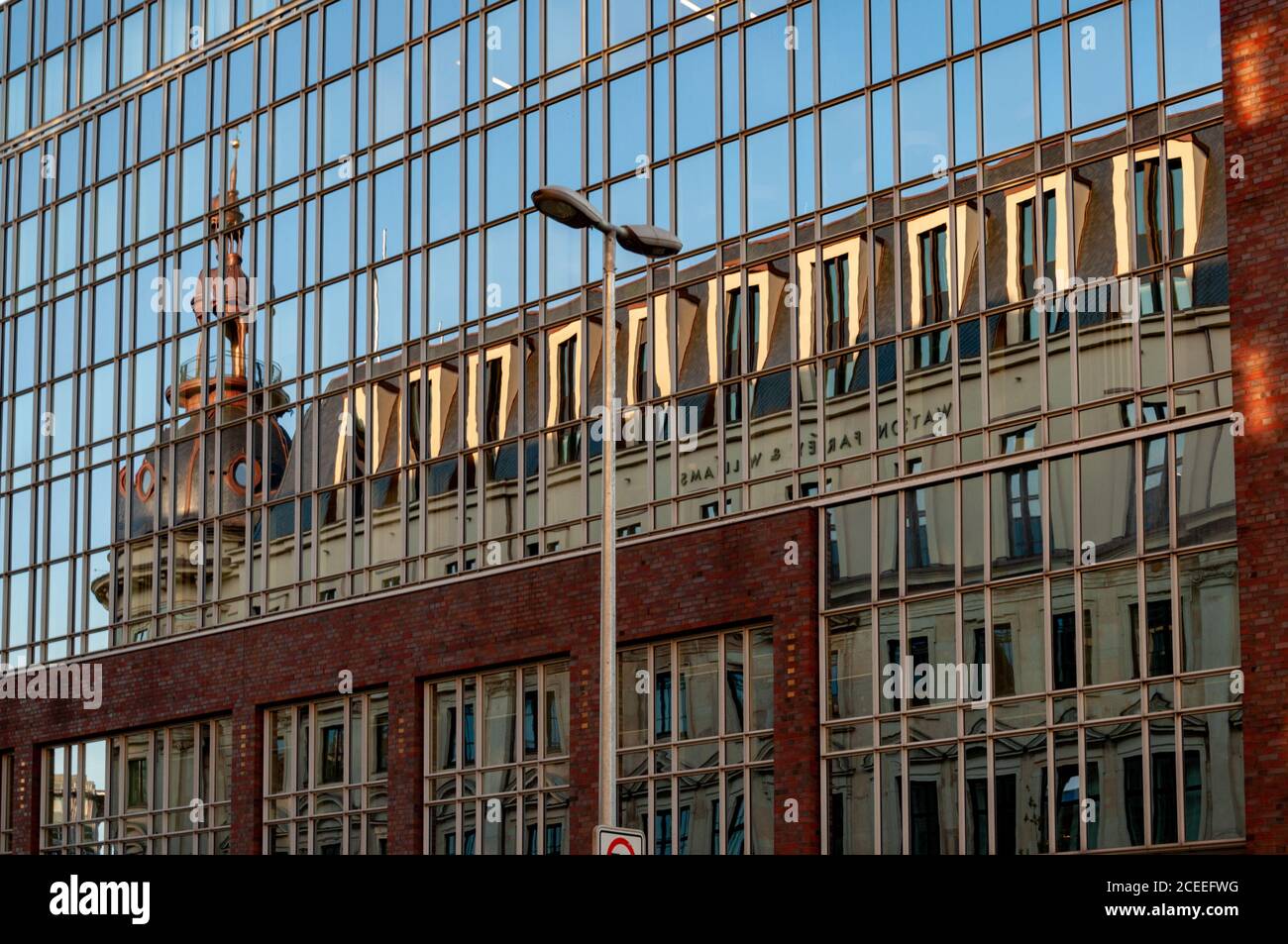Golden sunlight in distorted reflection of historic building with ...
