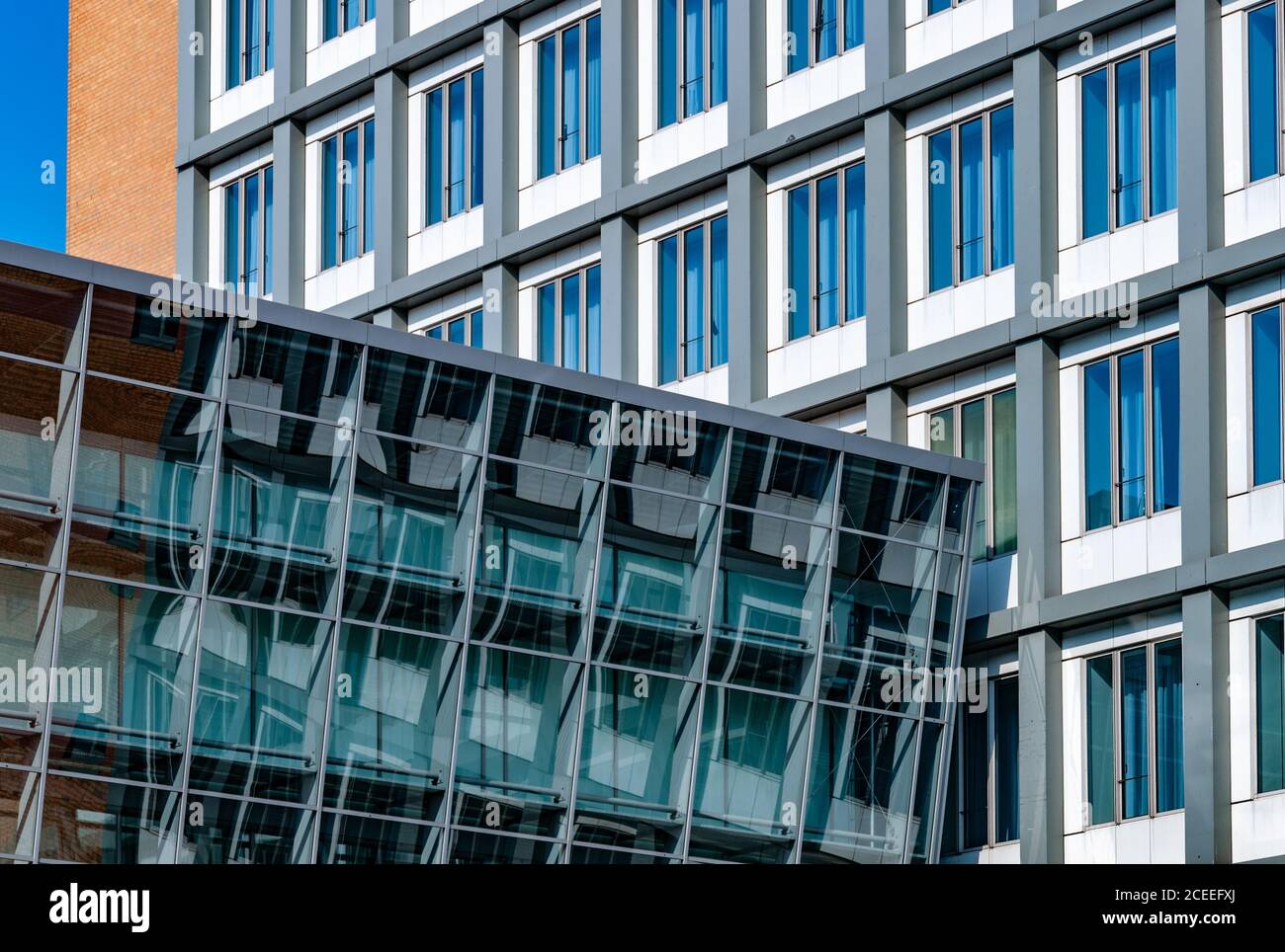 Abstract distorted reflections in glass gallery corridor of modern ...