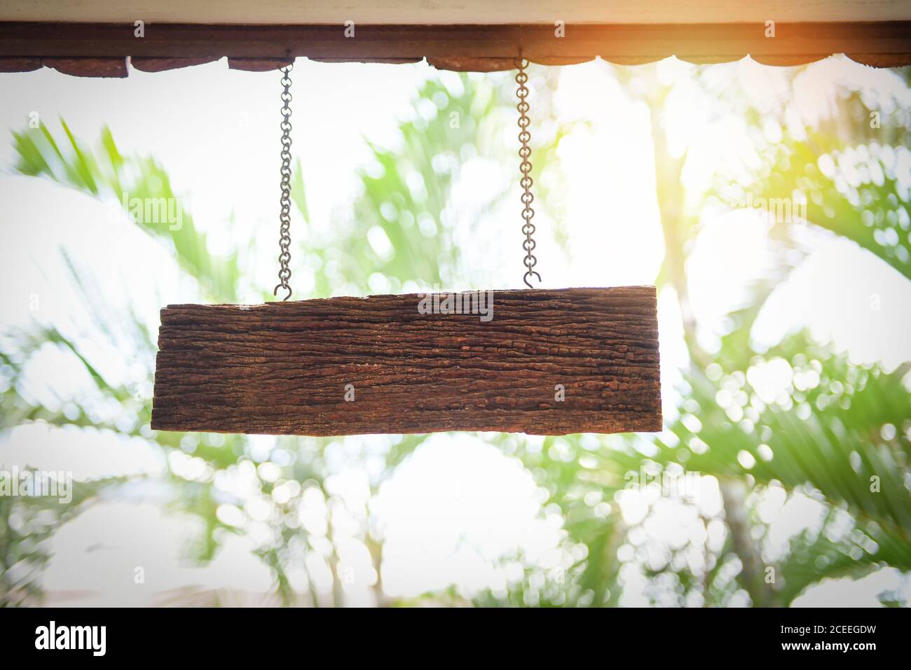 wooden sign hanging from roof / light wood rustic signboard on aged ...