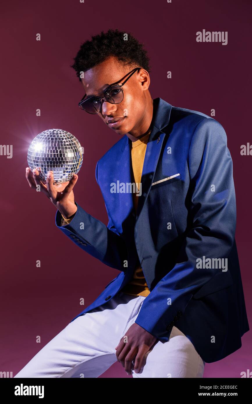 Trendy party man with disco ball Stock Photo - Alamy