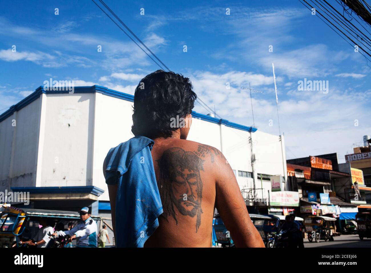 PHILIPPINES - February 10, 2014: Back view of shirtless man with tattoo ...