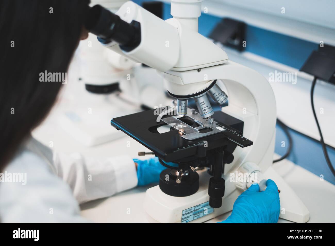 Woman using microscope hi-res stock photography and images - Alamy