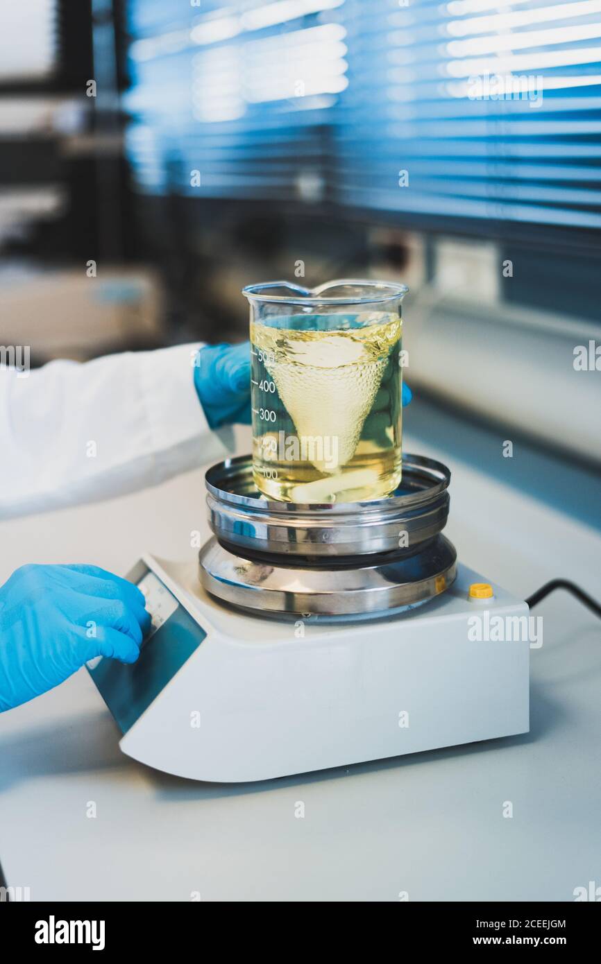 Dosing cup with liquid placed on scale Stock Photo - Alamy