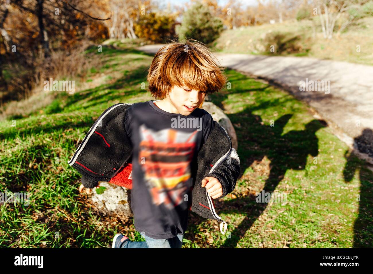boy running alone by a path in the countryside Stock Photo - Alamy
