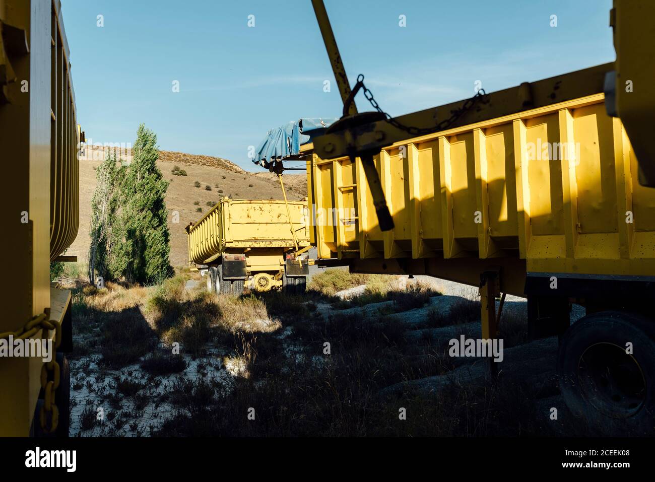 Old trailers abandoned close to a black gravel pile at a quarry Stock ...