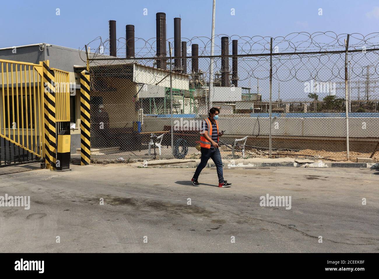 01 September 2020, Palestinian Territories, Nuseirat: A worker walks at ...