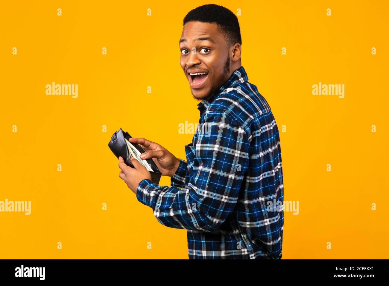 Excited African Man Holding Wallet With Money Over Yellow Background ...