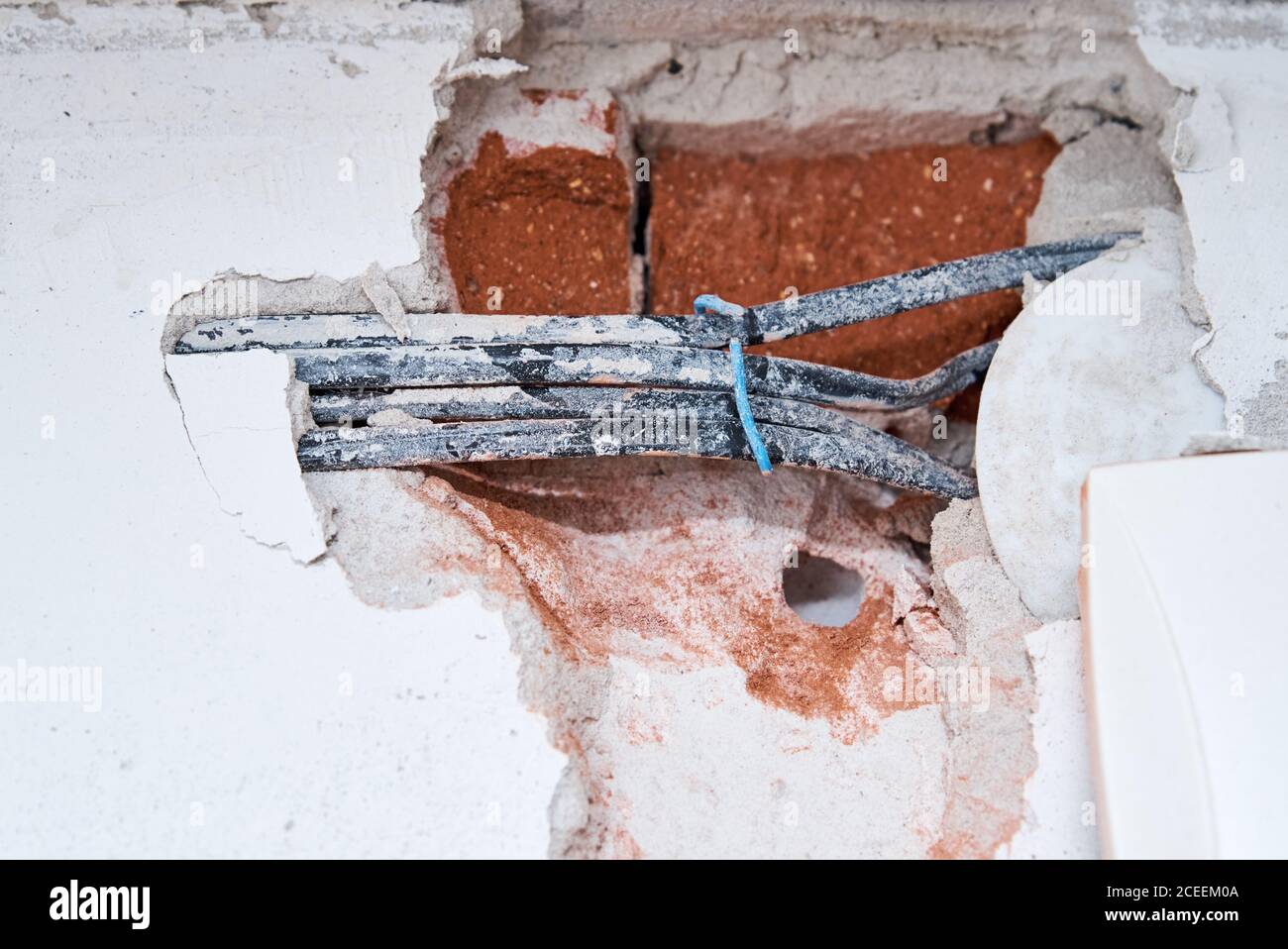 Old electrical cables in brick wall. Danger wiring Stock Photo - Alamy