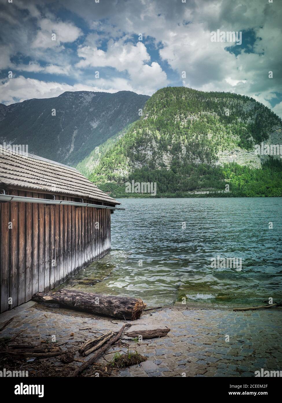 View on Hallstatter lake and wooden house in Hallstatt city. Cloudy sky ...