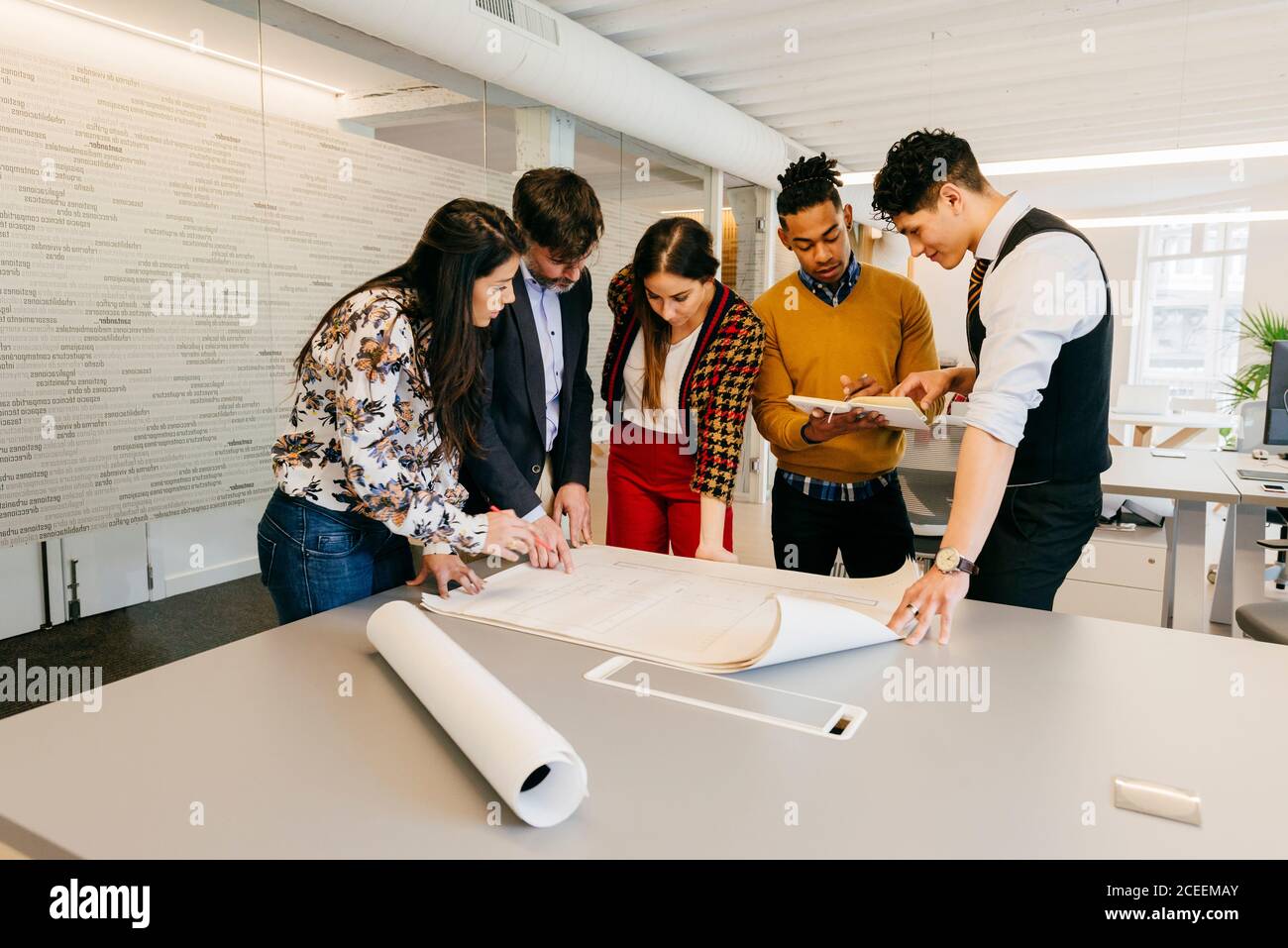 Office team working with blueprints Stock Photo - Alamy