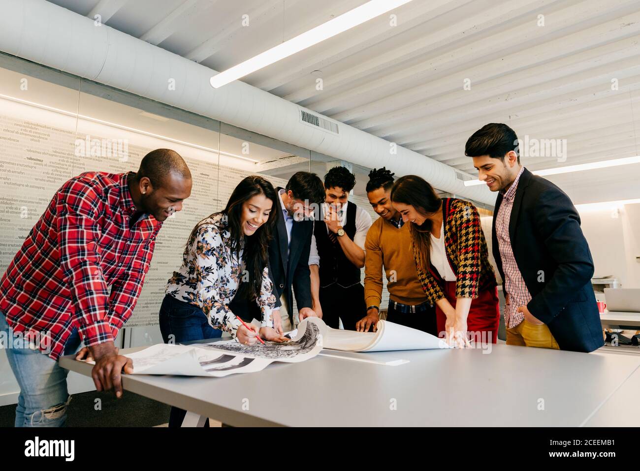 Office team working with blueprints Stock Photo - Alamy