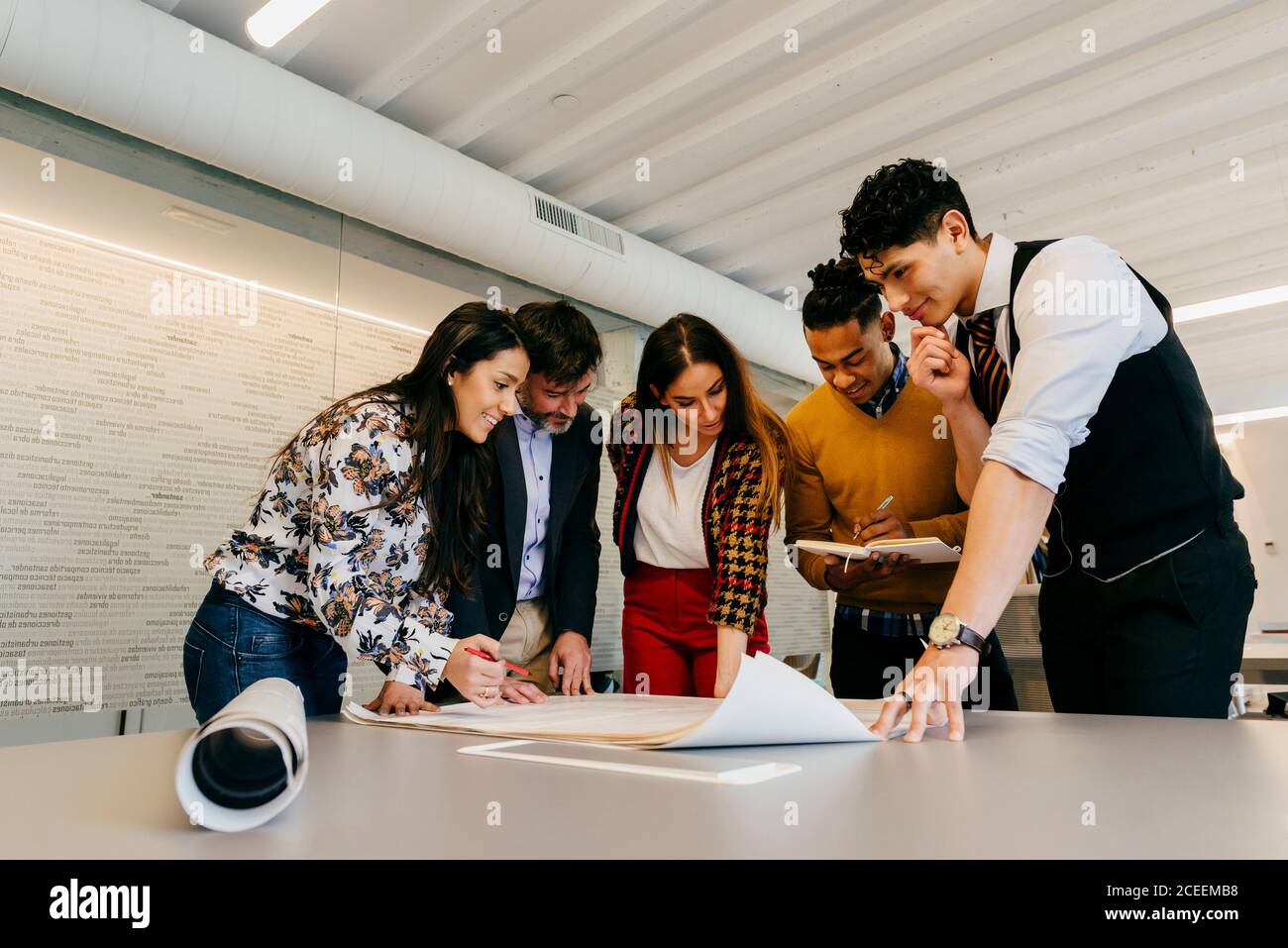 Office team working with blueprints Stock Photo - Alamy