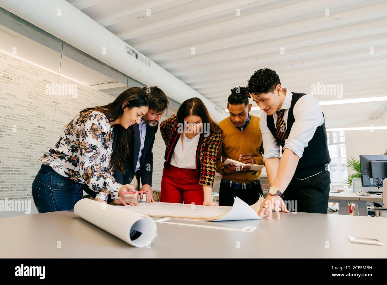 Office team working with blueprints Stock Photo - Alamy