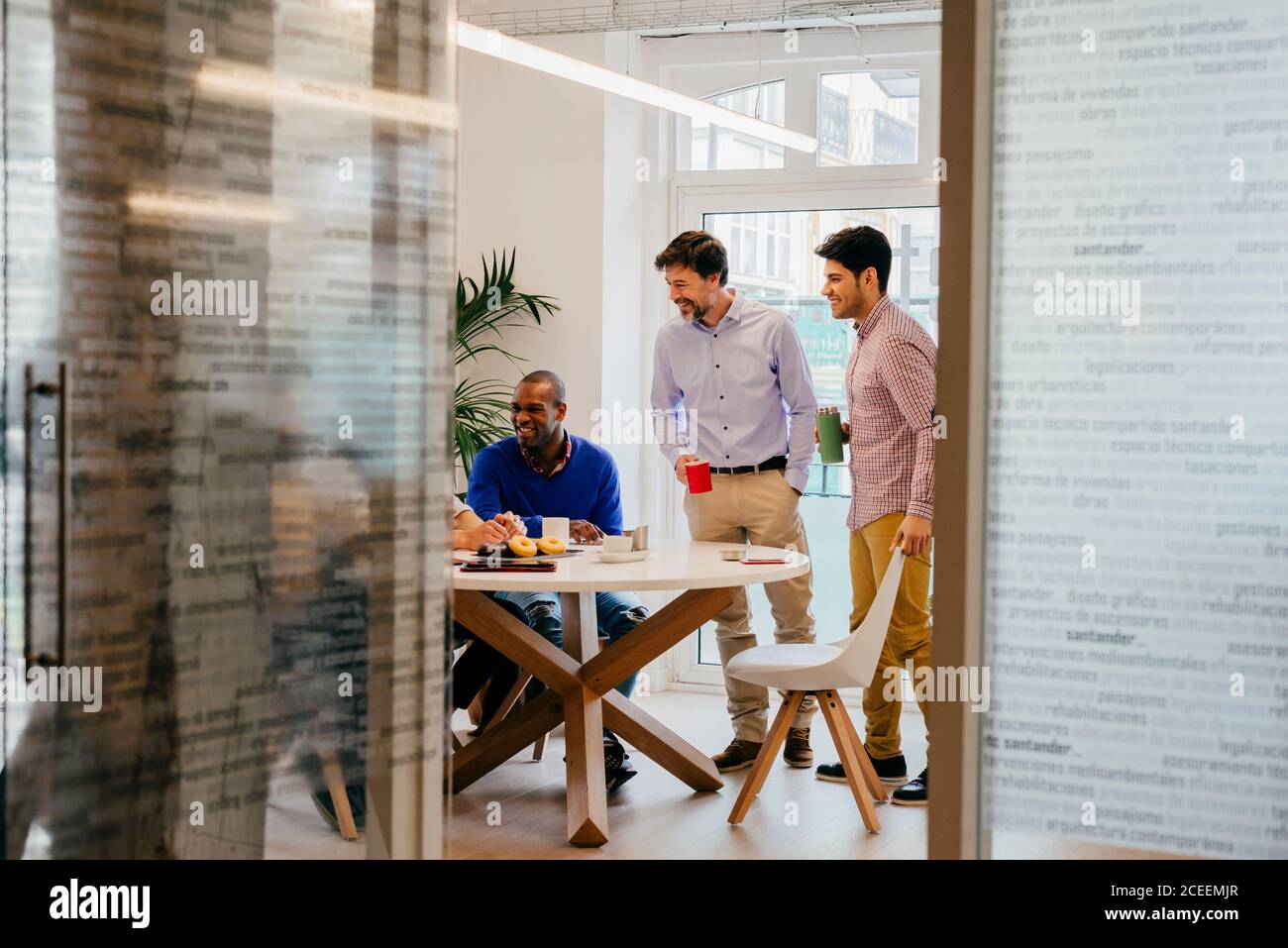 Group co workers standing in office hi-res stock photography and images ...