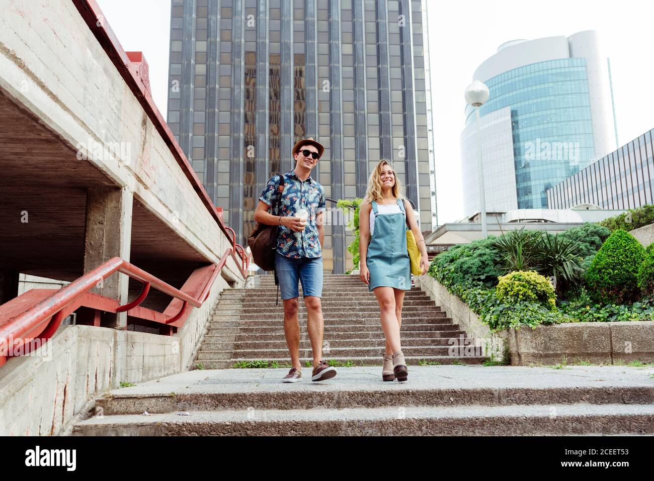 Couple walking downstairs Stock Photo - Alamy