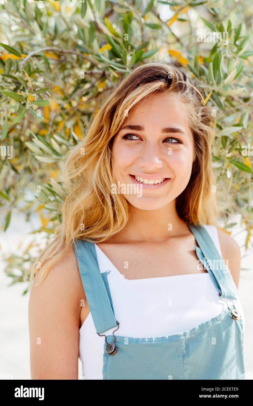 Smiling Woman at tree Stock Photo - Alamy