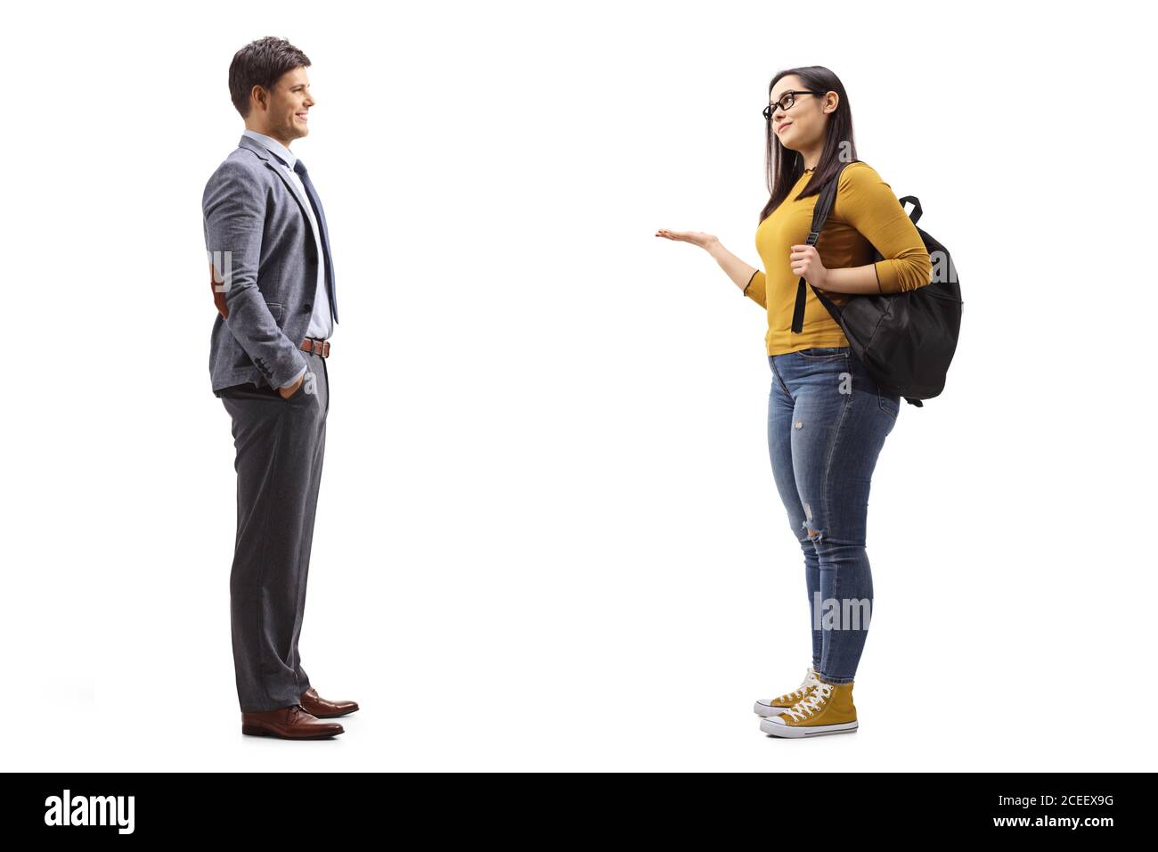 Full length profile shot of a female student talking to a man in a suit ...