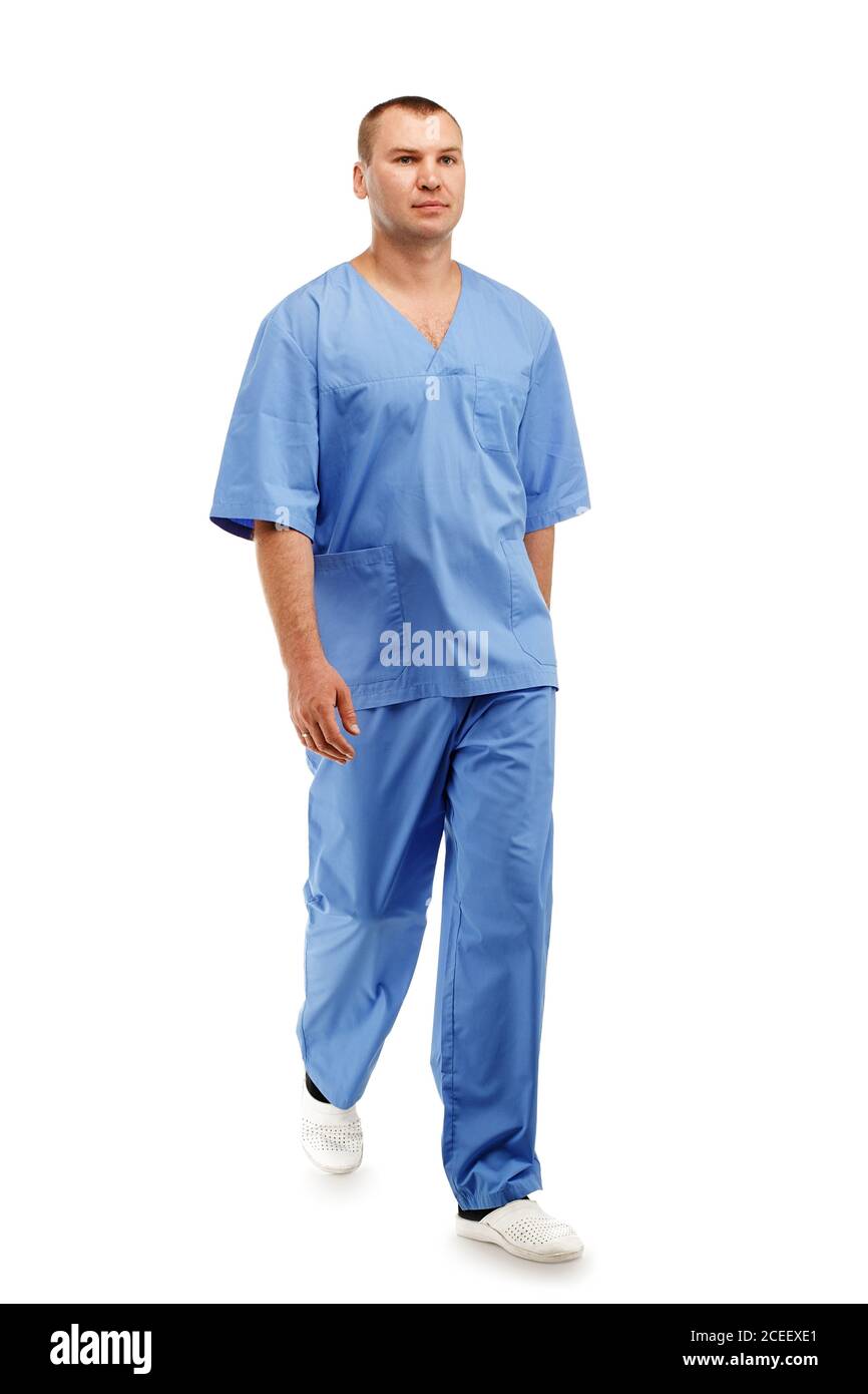 Full length portrait of a young male doctor in a medical surgical blue ...
