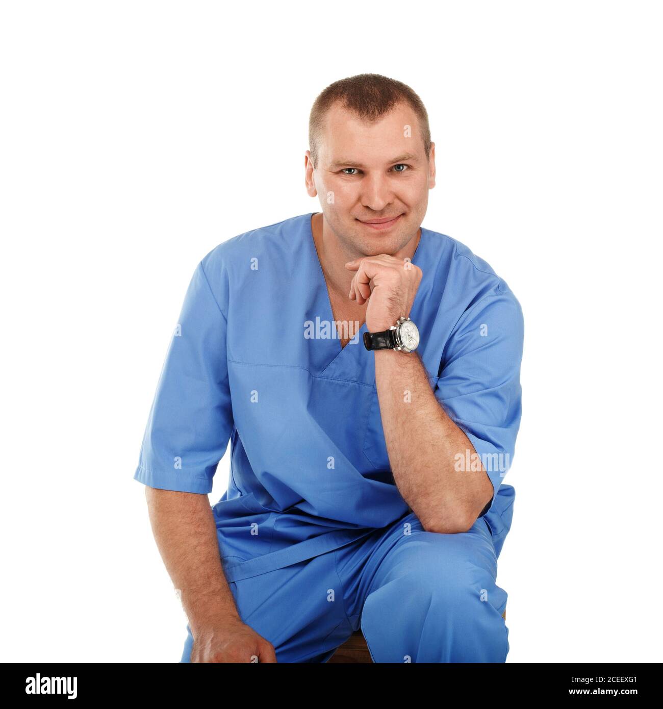 Portrait of a young male doctor in a medical surgical blue uniform ...