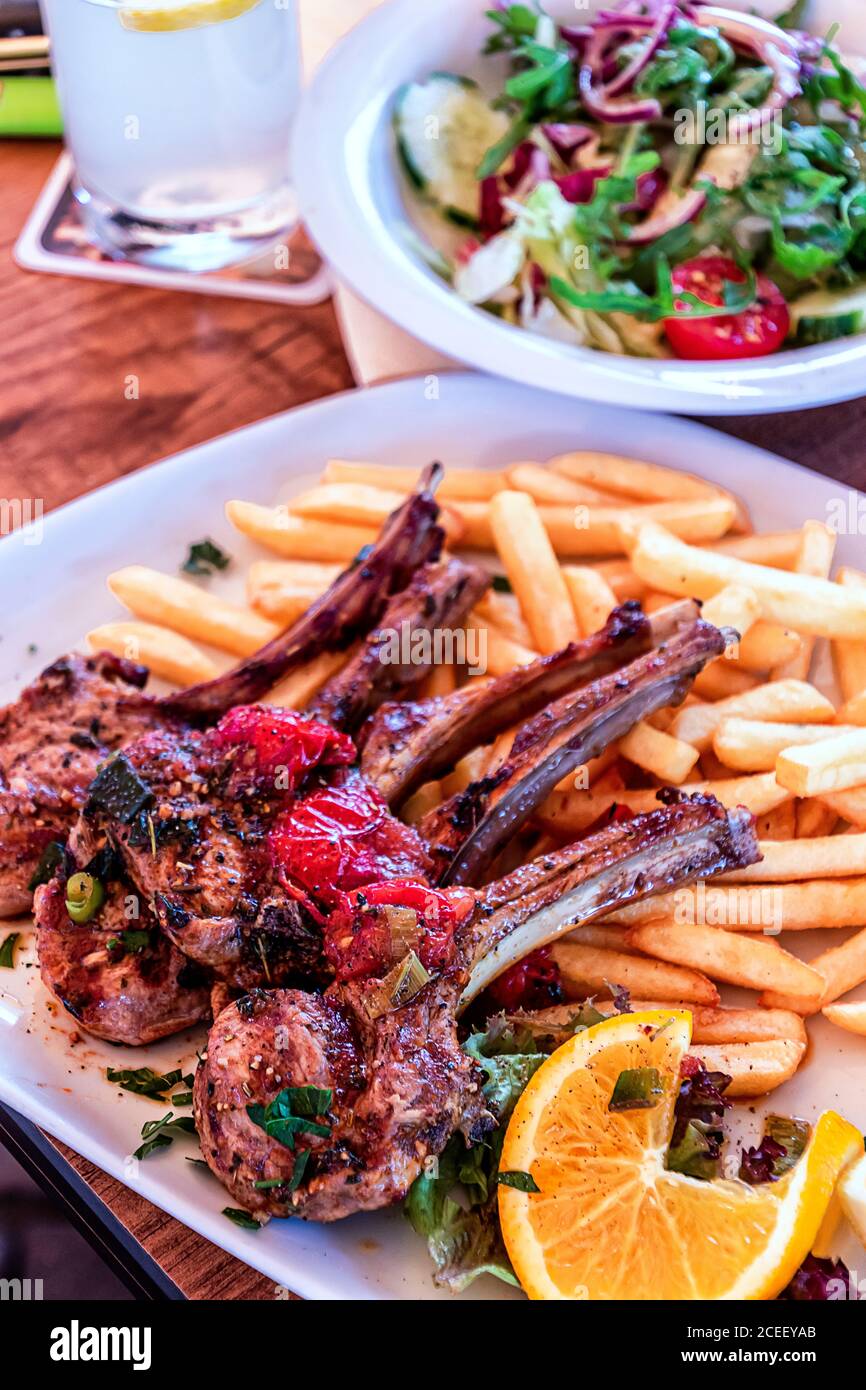 Grilled Lamb Chops with French fries and salad Stock Photo - Alamy
