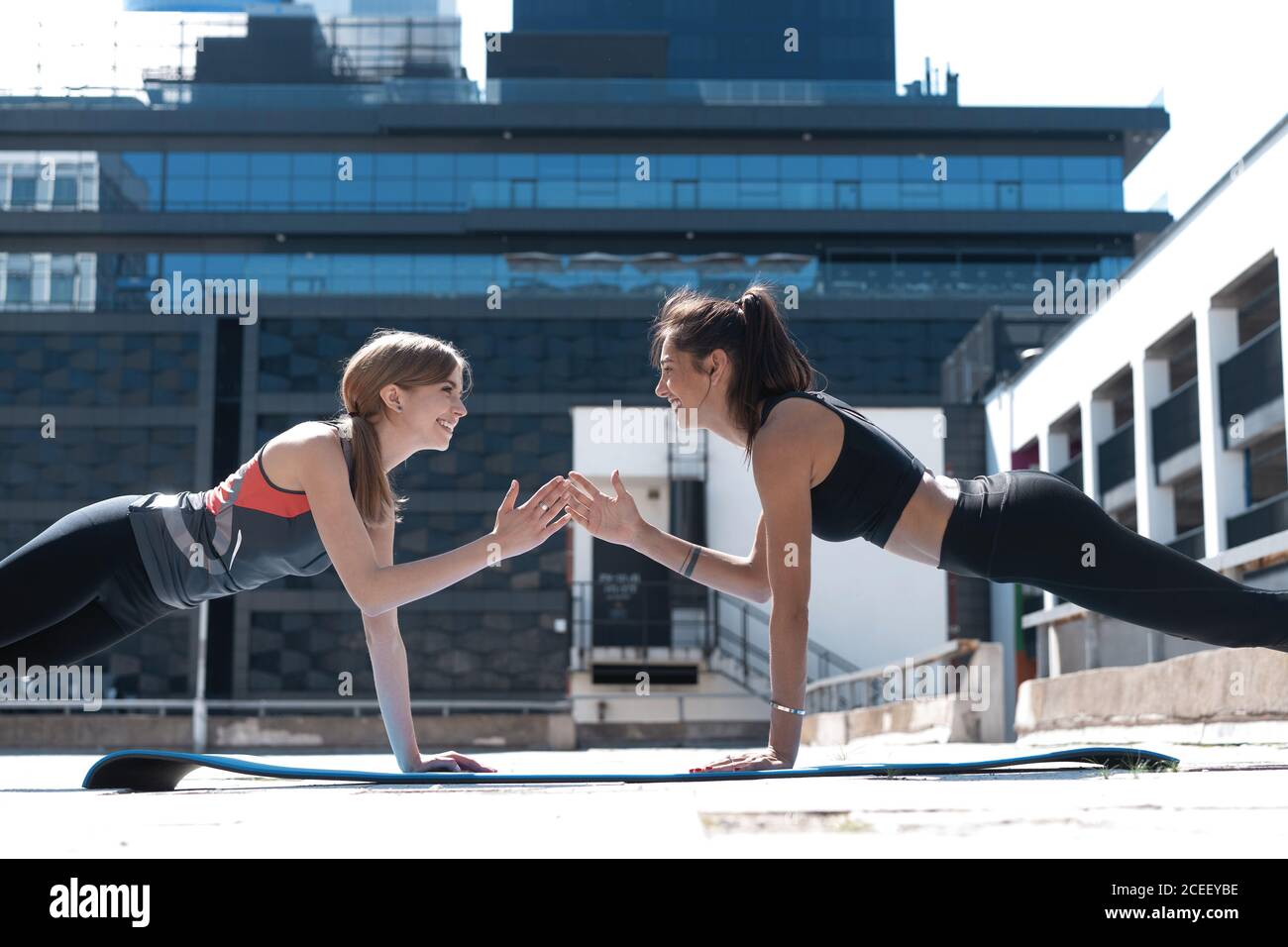 Two young girls making give five gesture after sport training outdoors ...