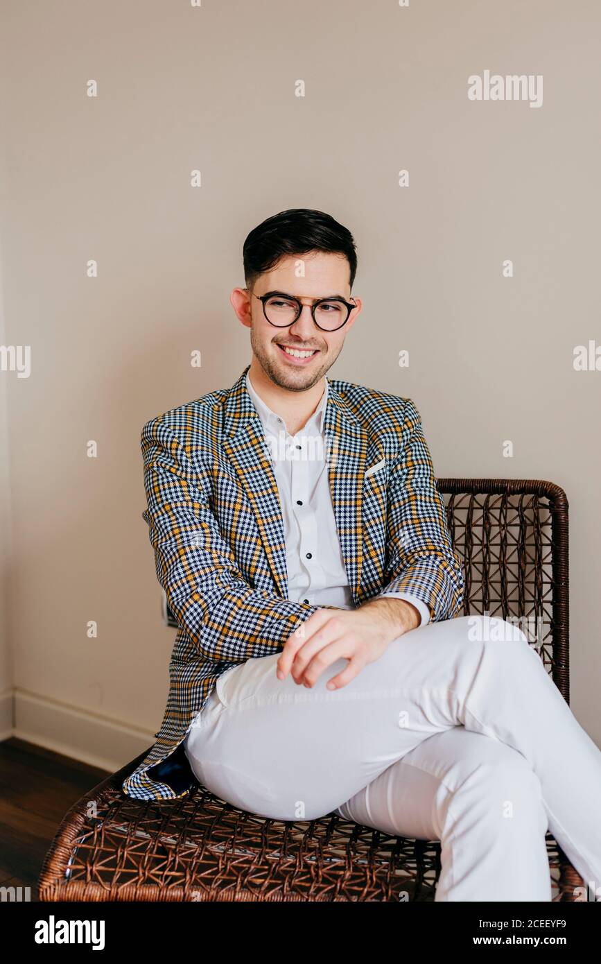 Trendy young man sitting chair hi-res stock photography and images - Alamy