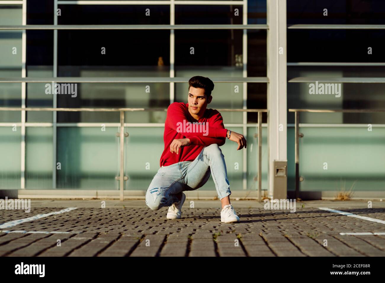 Male squatting hi-res stock photography and images - Alamy