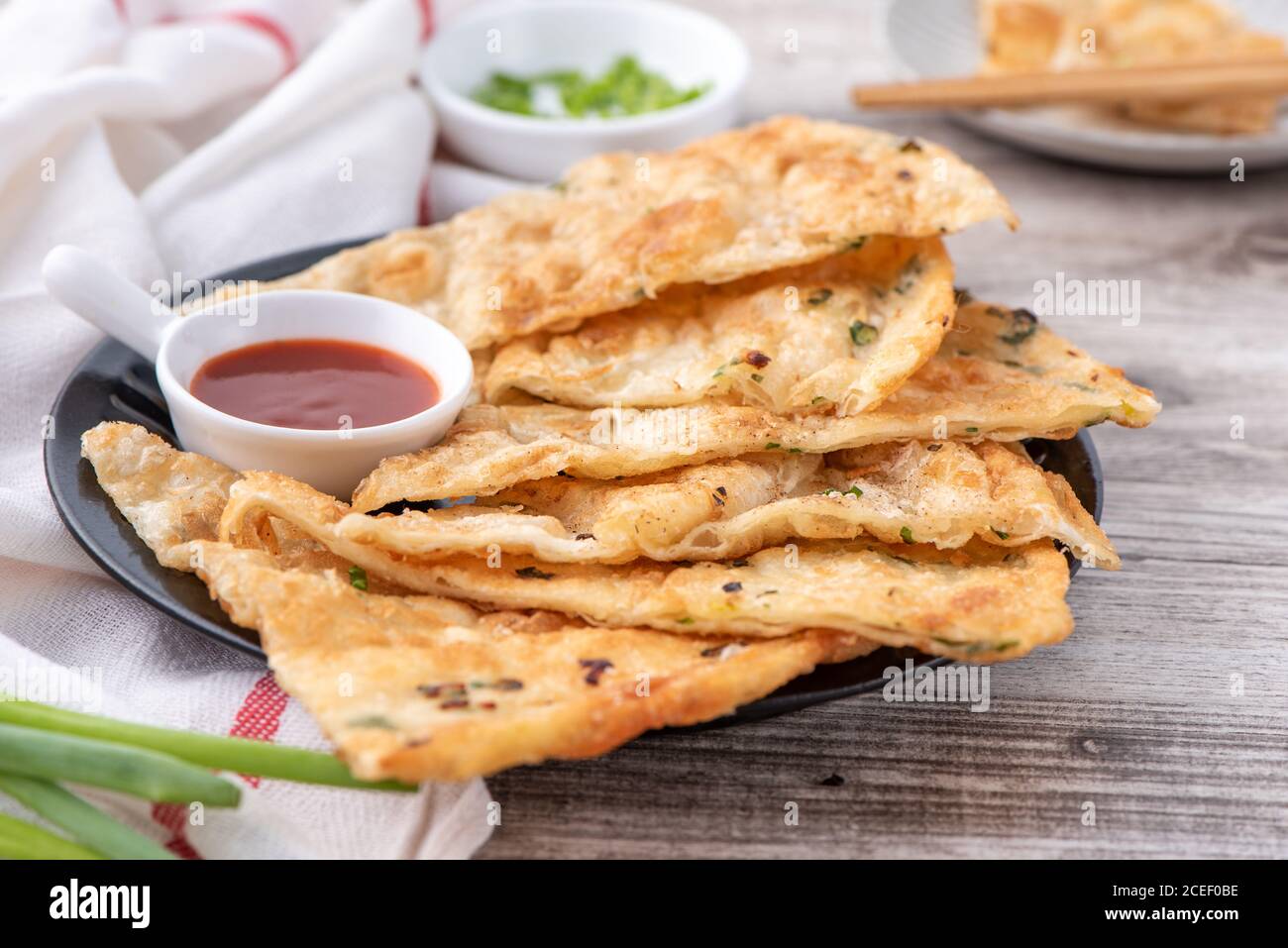 Taiwanese food - delicious flaky scallion pie pancakes on bright wooden ...