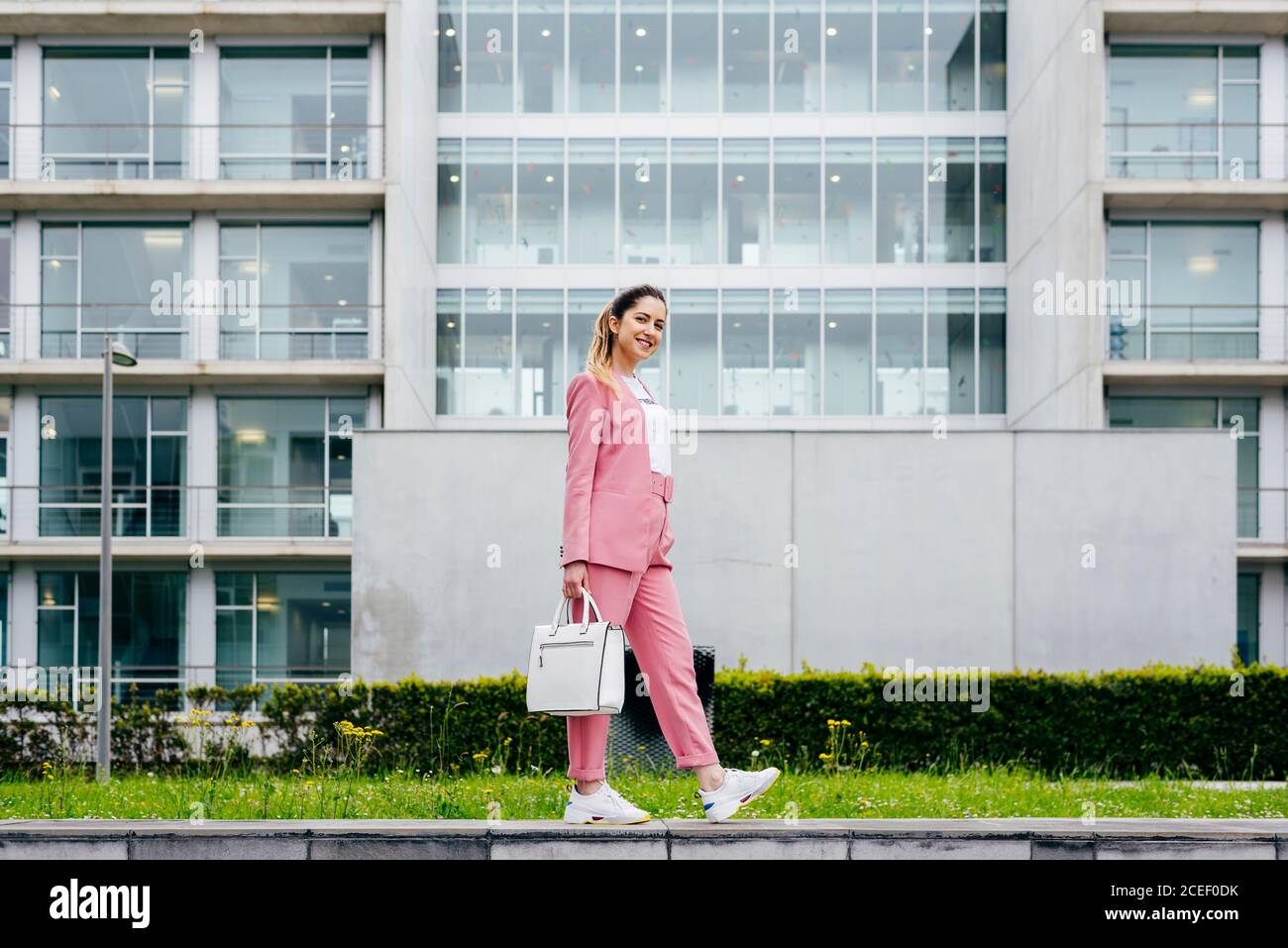 Stylish model in pink on street Stock Photo - Alamy