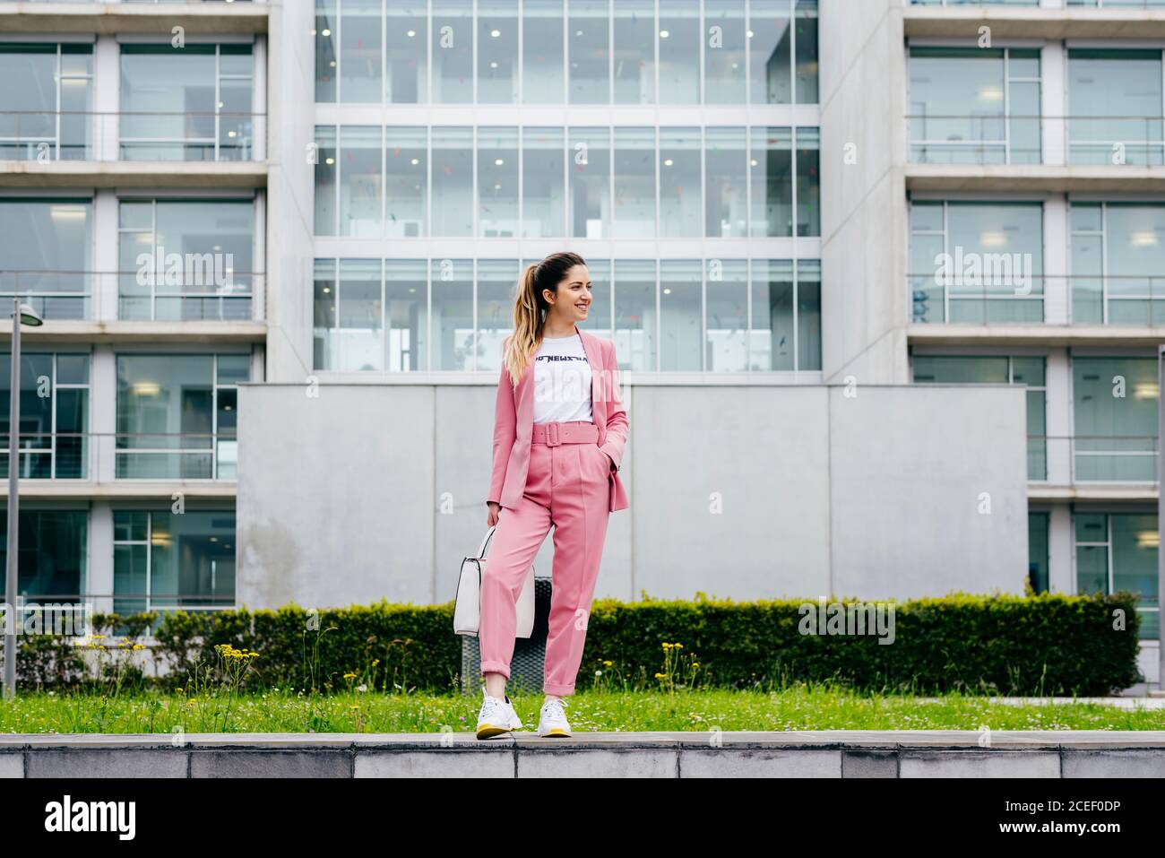 Stylish model in pink on street Stock Photo - Alamy