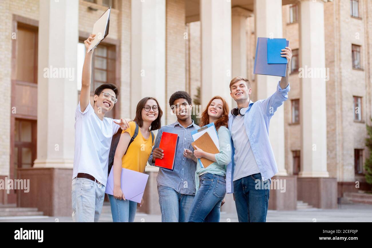 Cheerful Diverse Students Posing Standing Outside University Building ...