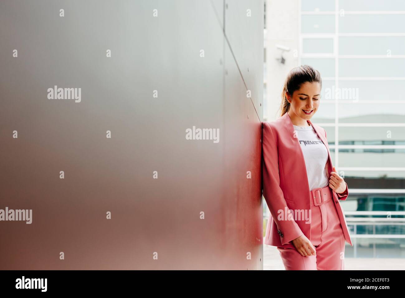 Stylish model in pink on street Stock Photo - Alamy