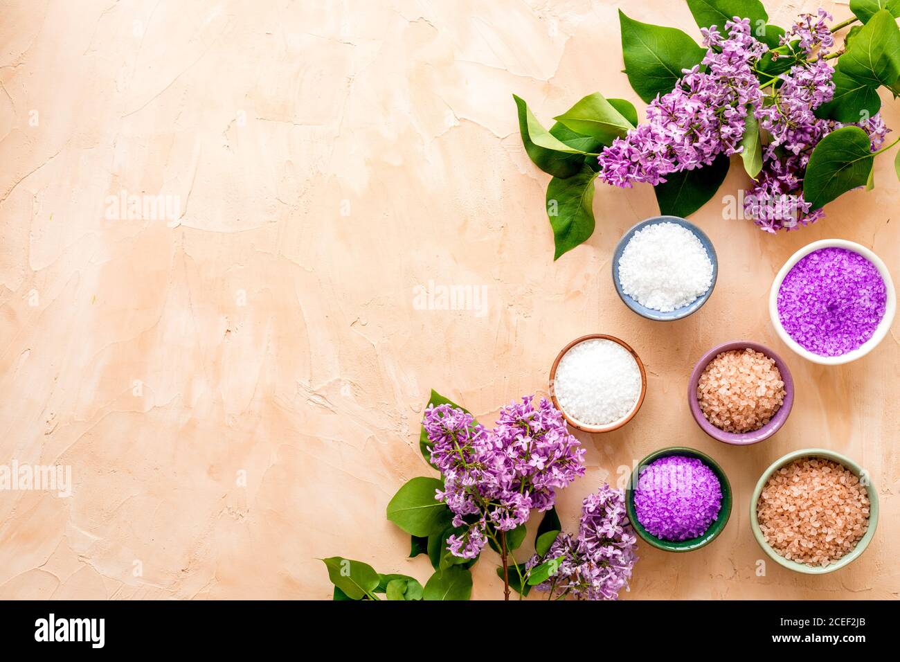 Sea salt spa set with pink lilac flowers. Top view Stock Photo - Alamy