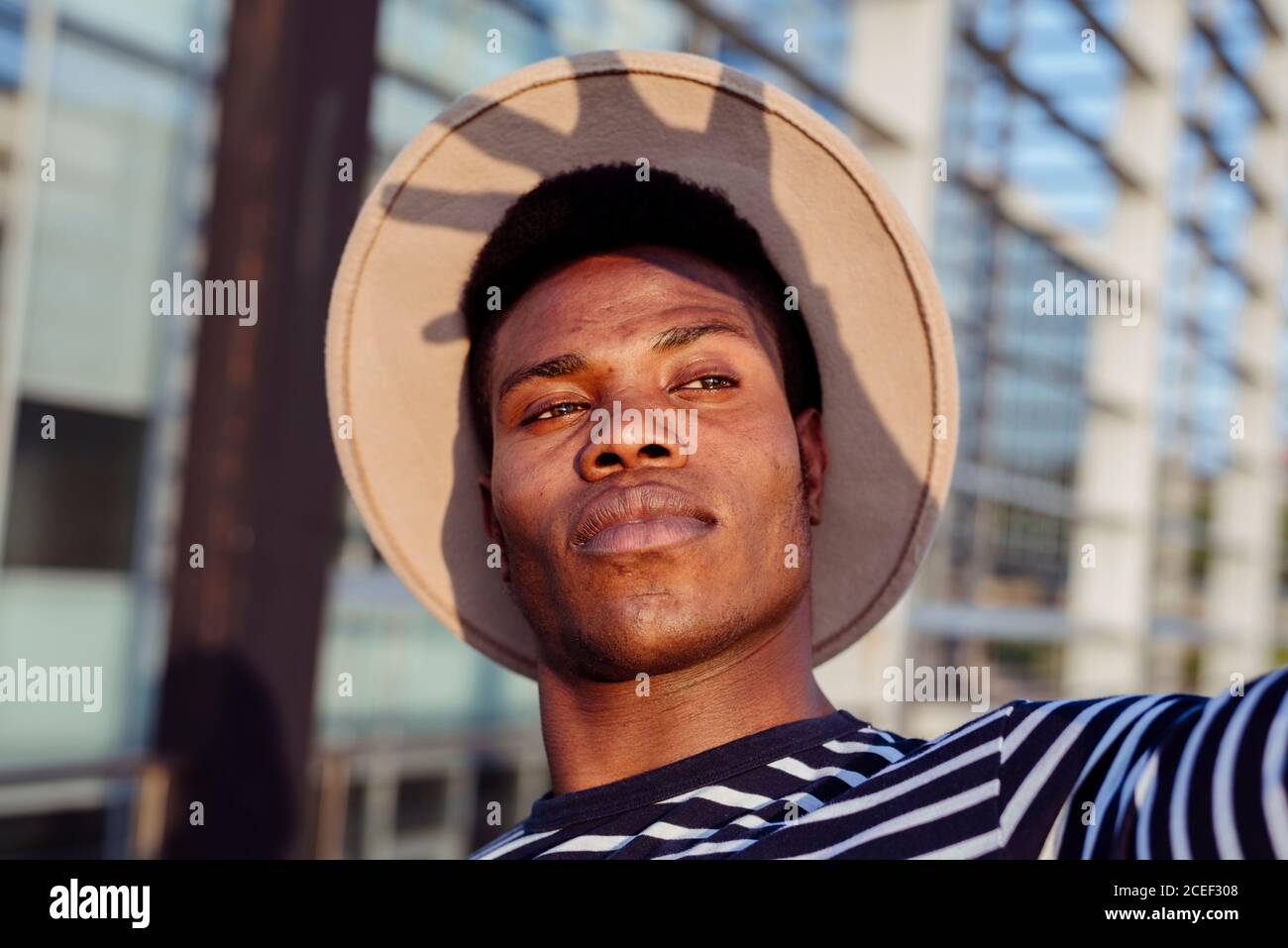 African-American man covering face from sun Stock Photo - Alamy