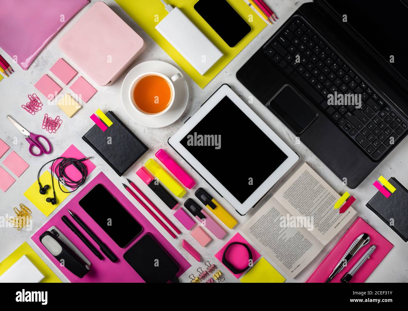 Workplace with colorful office tools and gadgets on the desk background ...