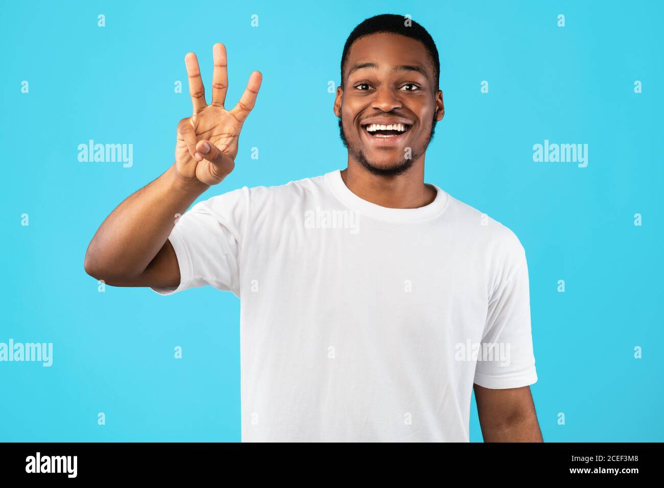 African American Guy Showing Three Fingers Counting Over Blue ...