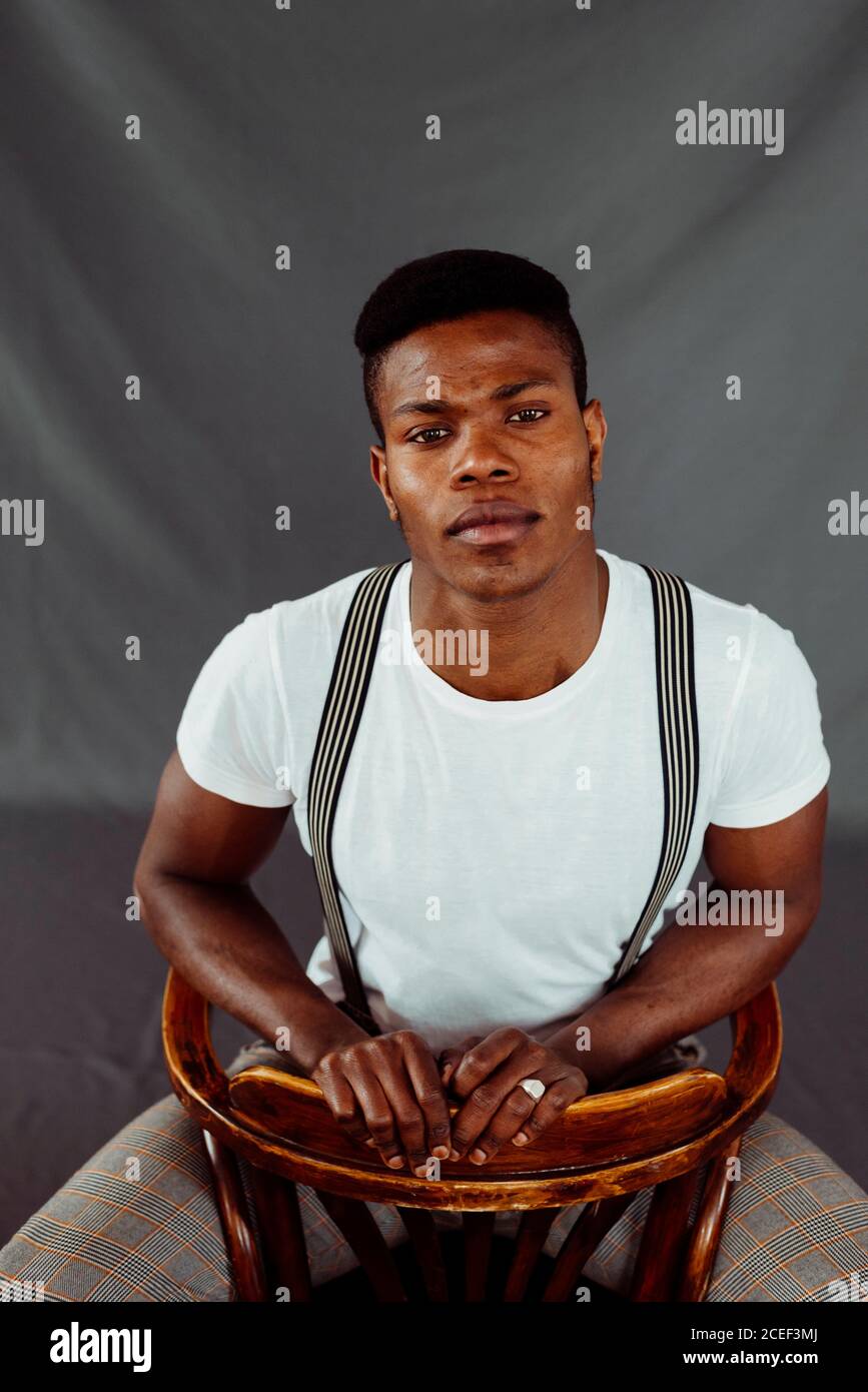 Black man sitting hi-res stock photography and images - Alamy