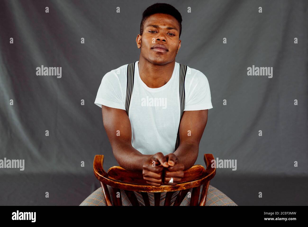 Black man sitting hi-res stock photography and images - Alamy