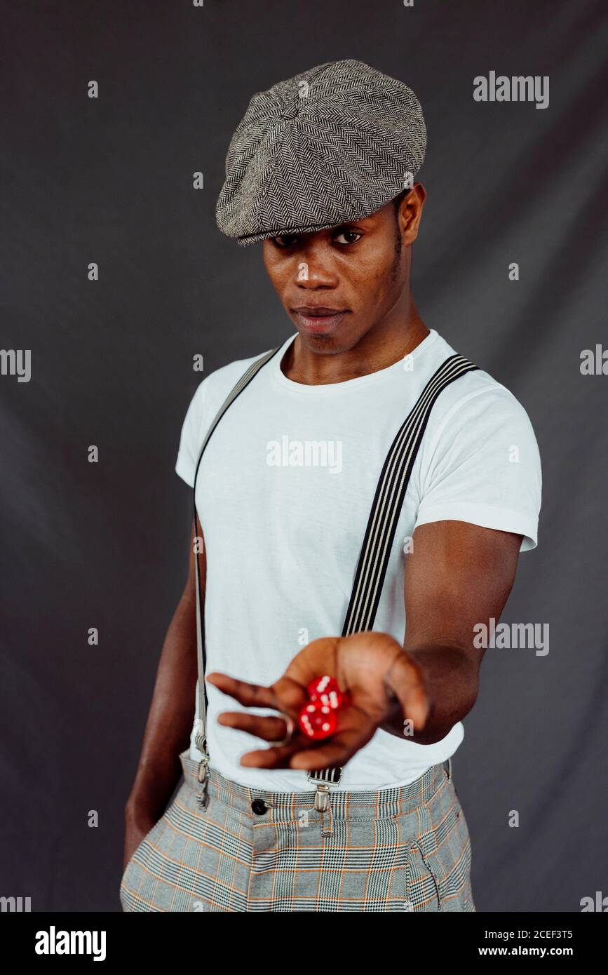 Black man showing dices Stock Photo - Alamy